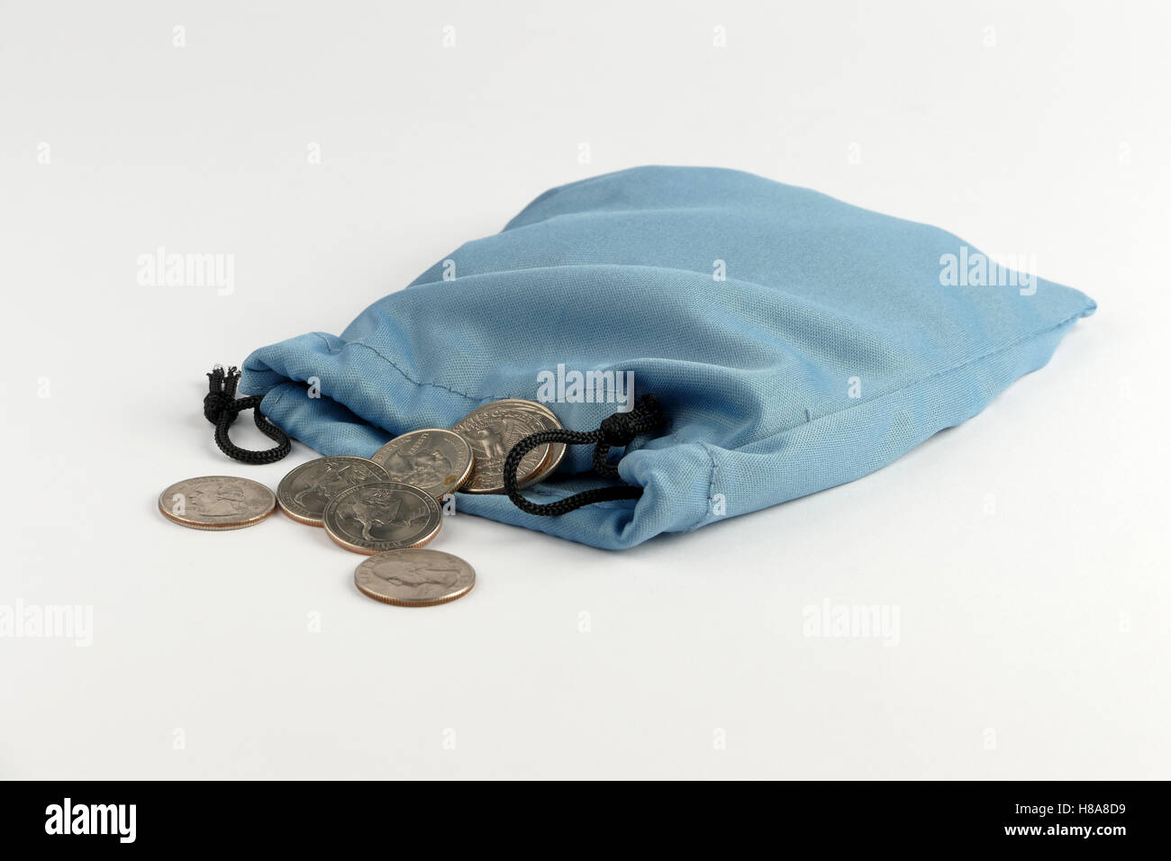 Bag full of coins isolated on white background Stock Photo - Alamy