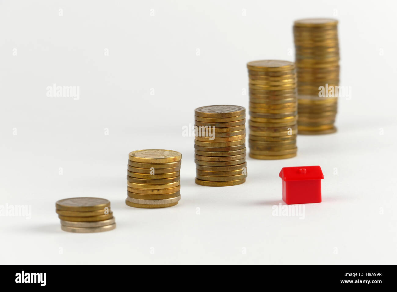 House and coins stack, realestate concept isolated on white background ...