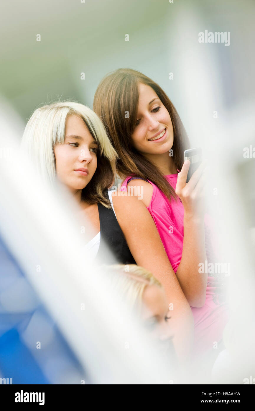 Two girls, 13, with a cell phone Stock Photo - Alamy