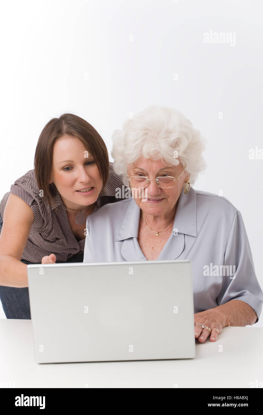 Child helping elderly with laptop hi-res stock photography and images ...