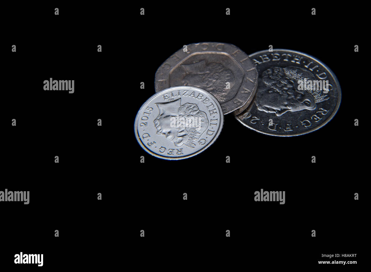 Loose change on black background Stock Photo - Alamy