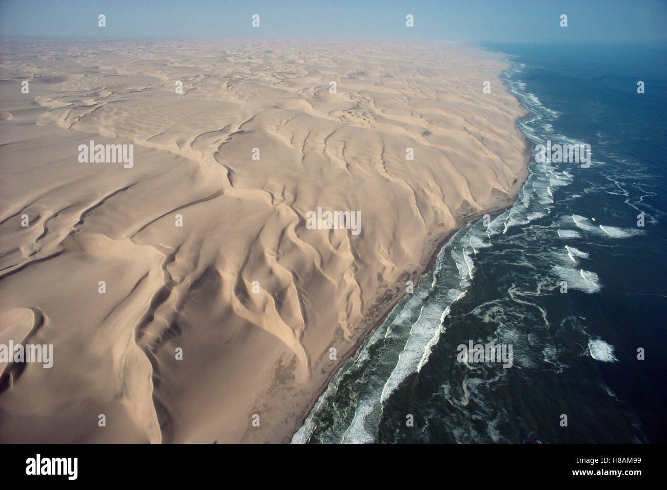 Aerial view of Namib Desert meeting Atlantic Ocean at the Skeleton ...