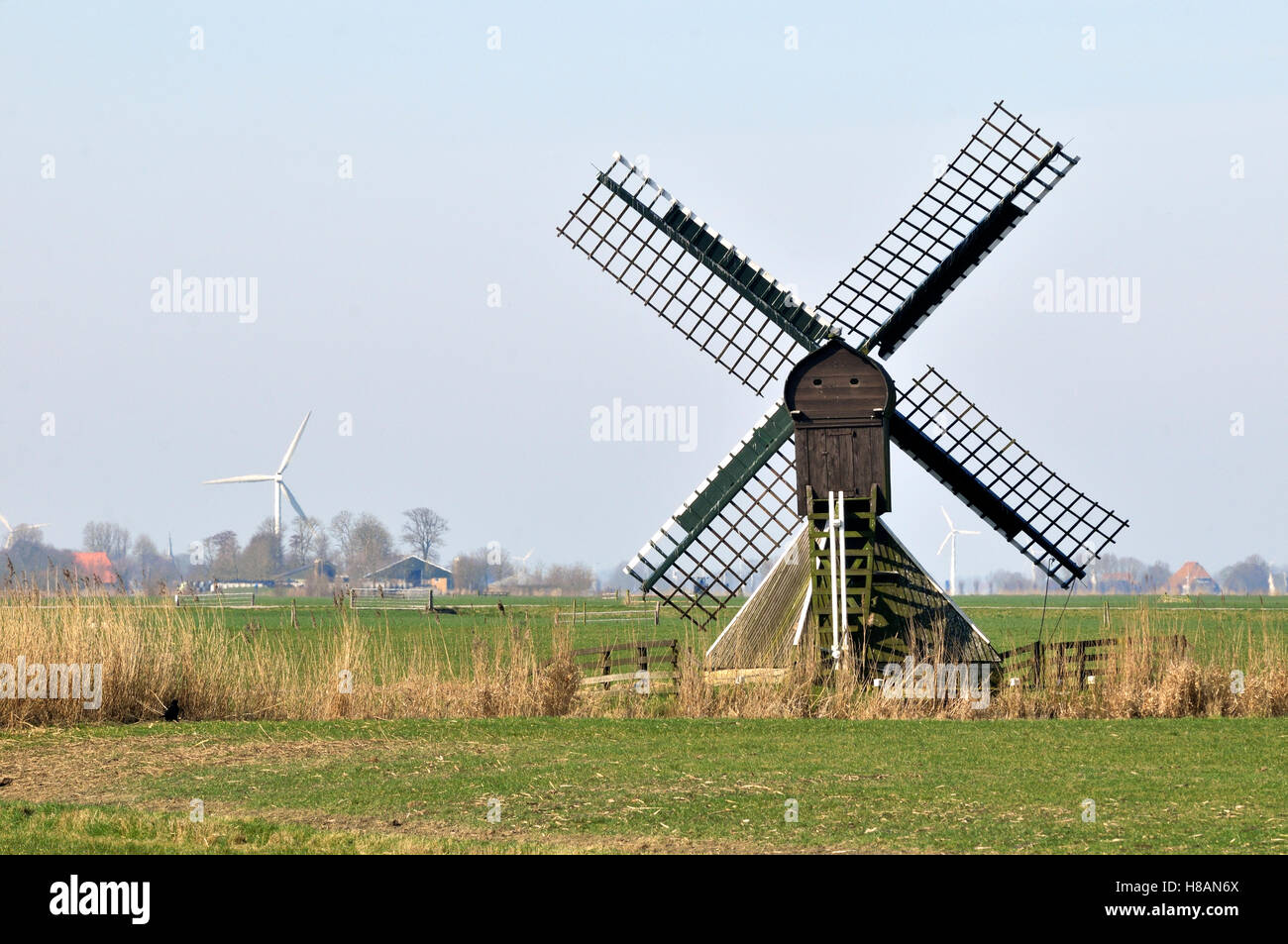Landscape with traditional water mill and modern energy windmill in ...
