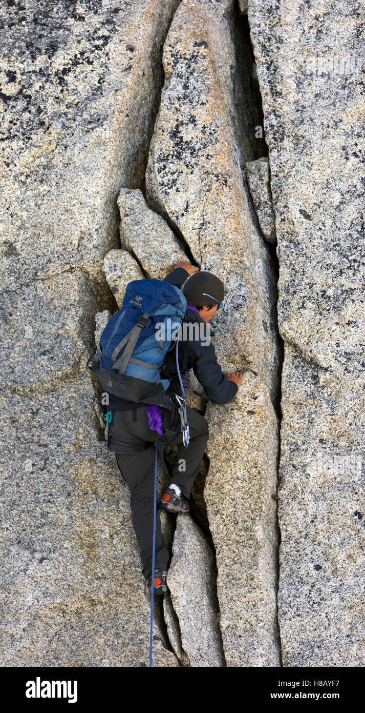 Mountaineer climbing rock face Stock Photo - Alamy