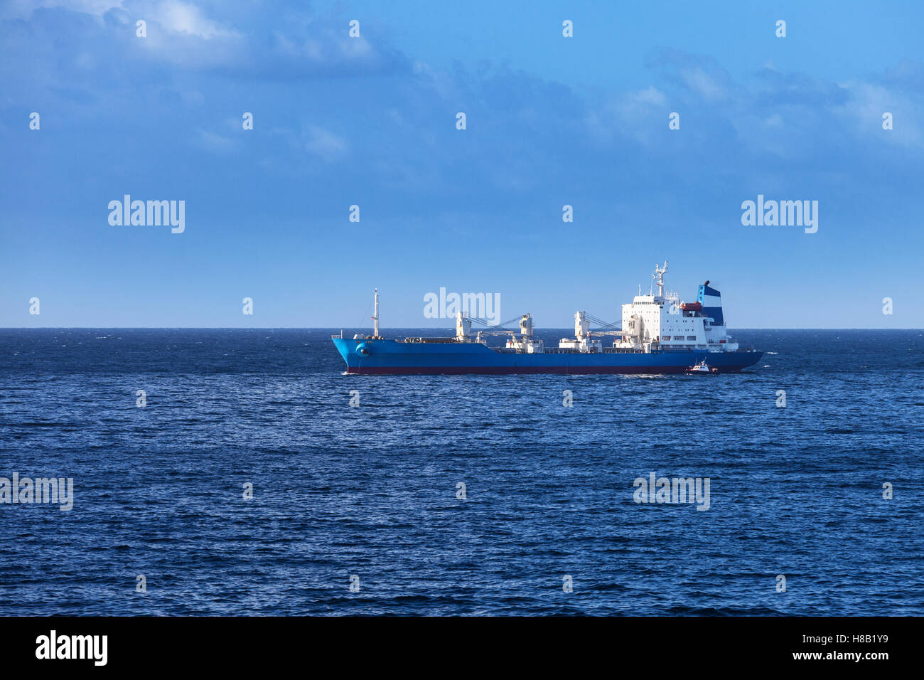 Cargo ship in the calm ocean Stock Photo - Alamy