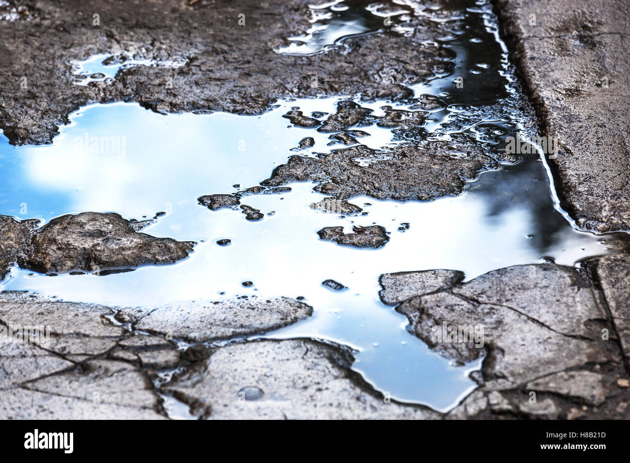 rain puddles on the pavement in the city Stock Photo - Alamy