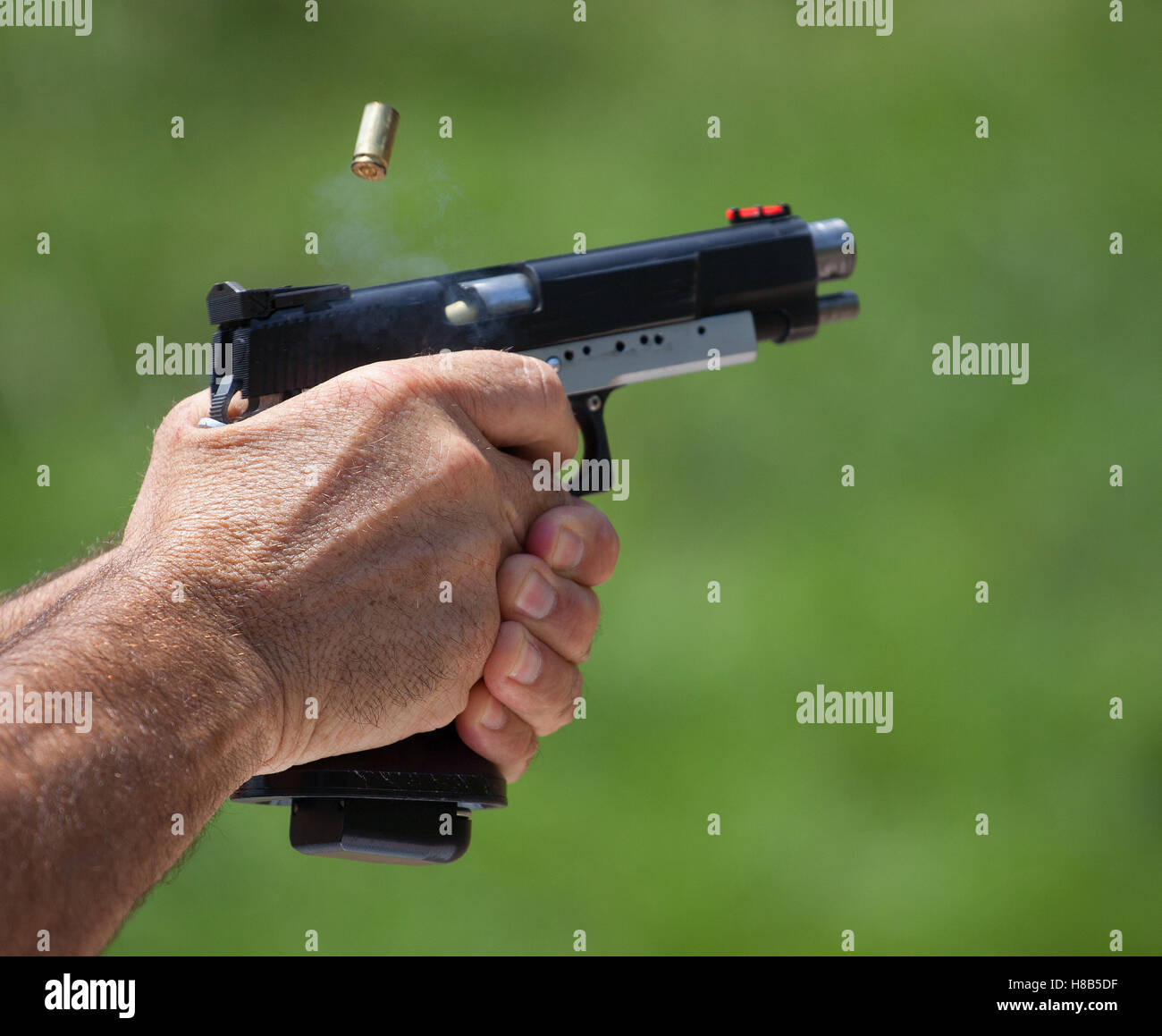 Handgun that is going back into battery and picking up another shell ...