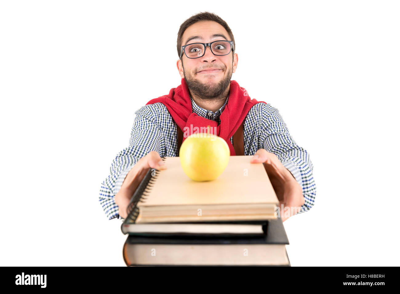 nerd student posing with books and apple isolated in a white background ...
