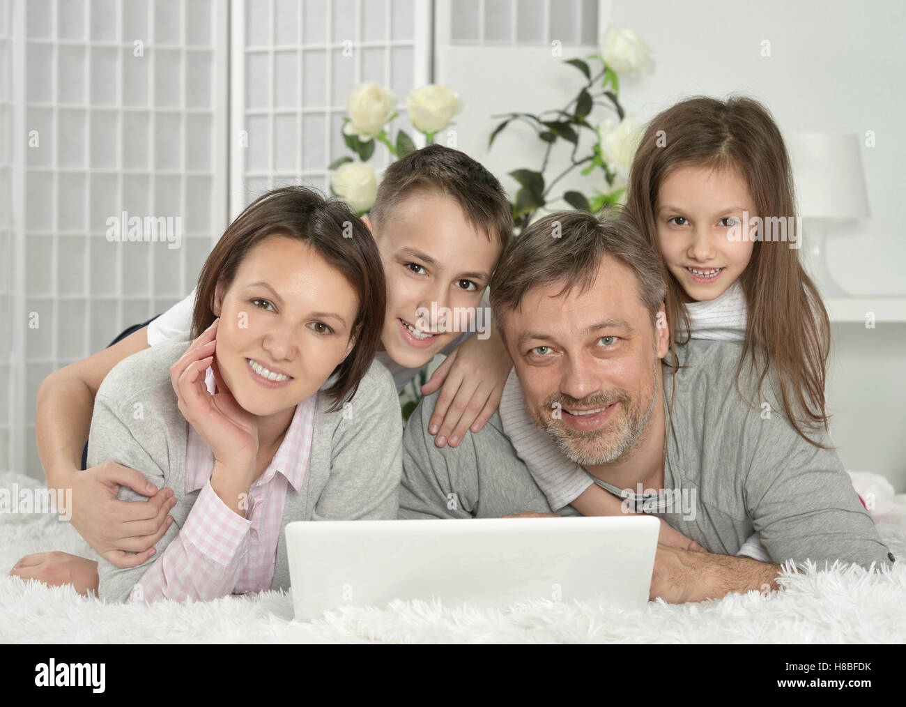 Happy family with laptop Stock Photo - Alamy