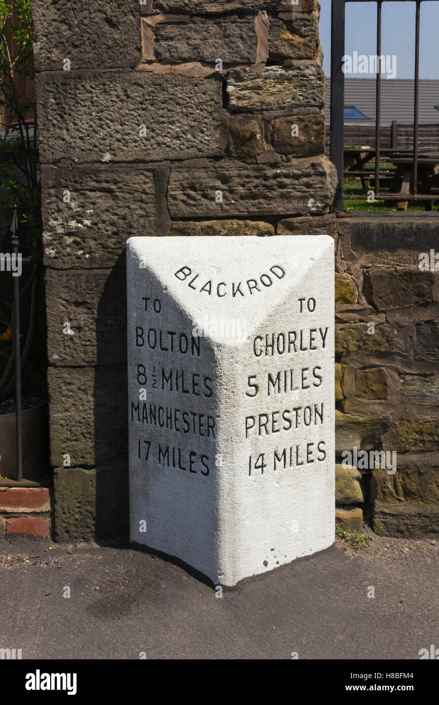 Milestone in the village of Blackrod, near Bolton, Lancashire, showing ...
