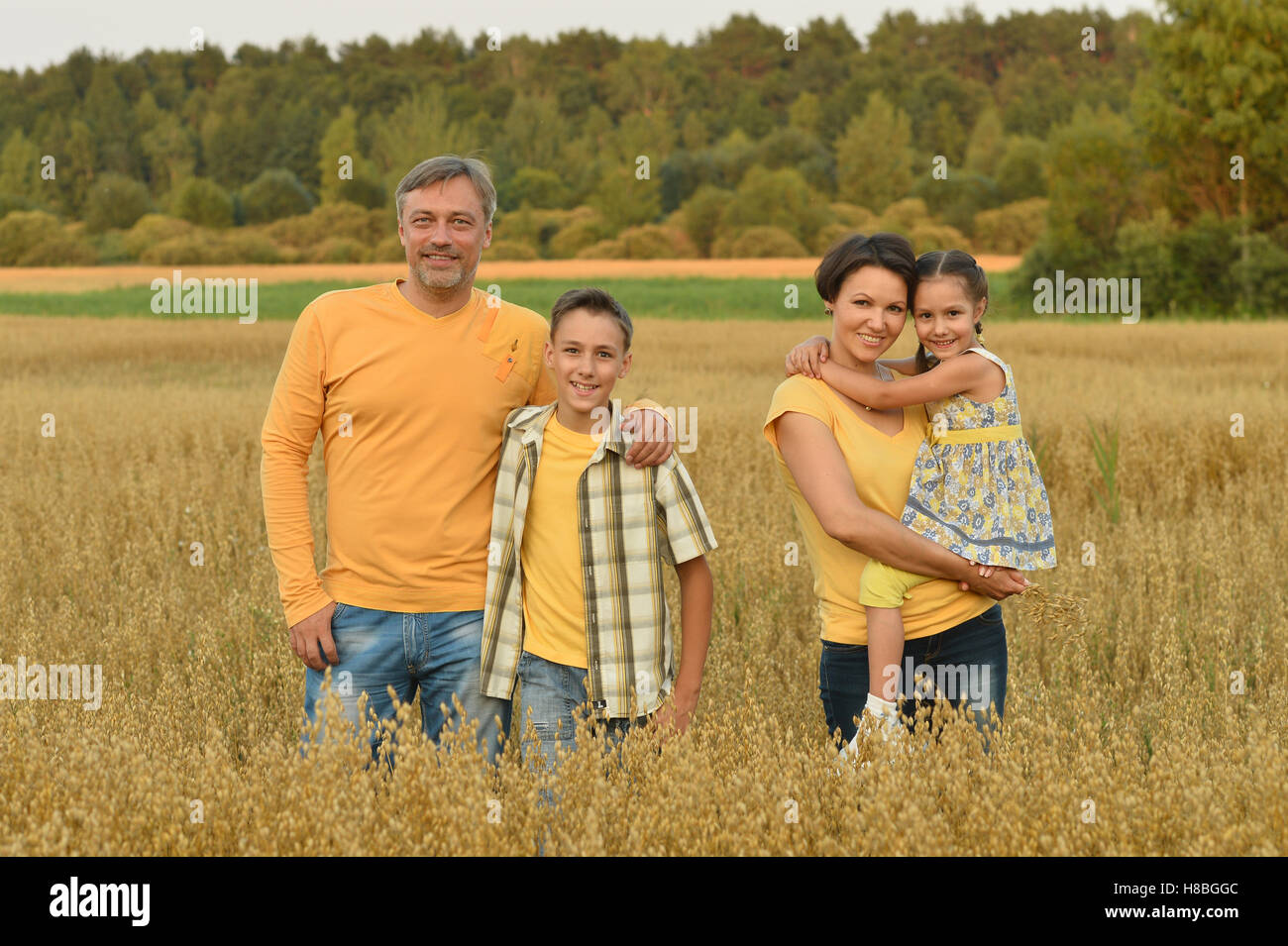 happy family at field Stock Photo - Alamy
