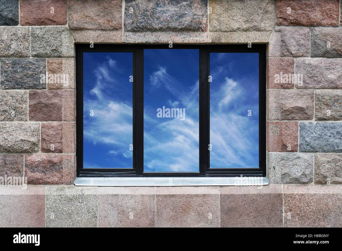 In a building wall from large granite blocks there is a window. In ...