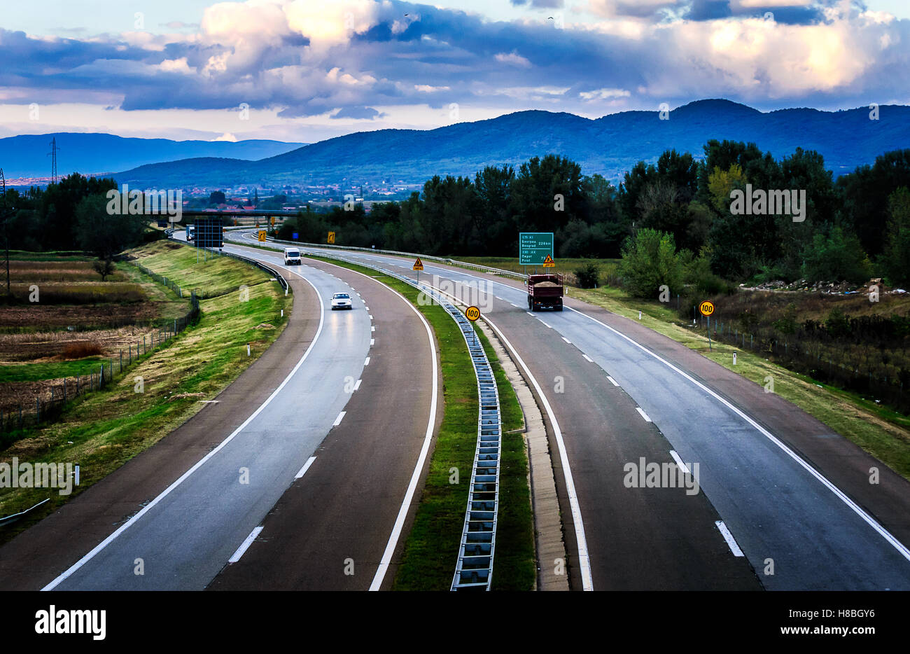 Open highway through pastoral landscape with light traffic Stock Photo ...