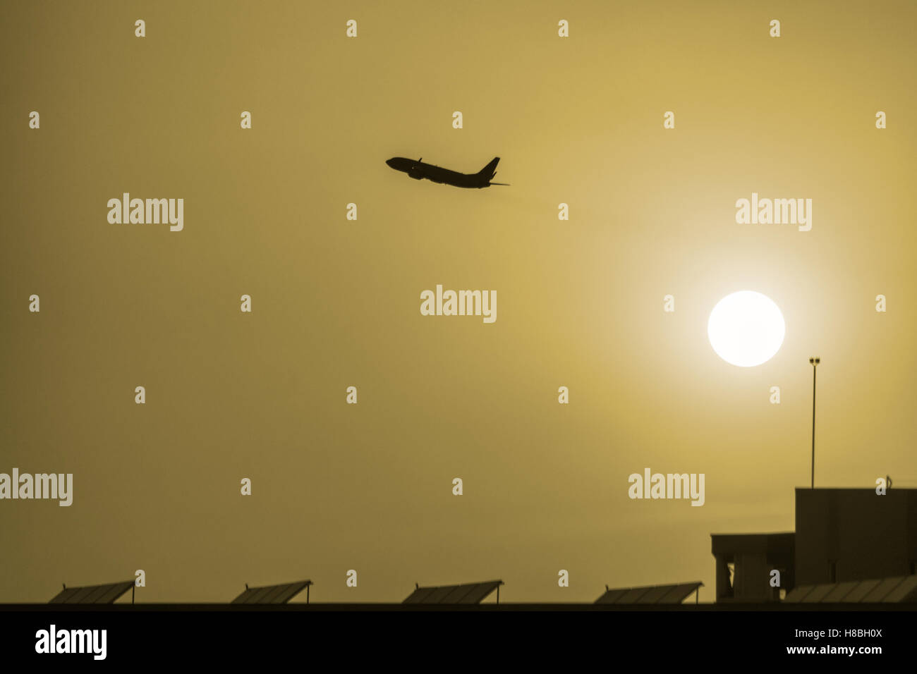 skyline early in the morning, plane is flying over the sun rising Stock ...