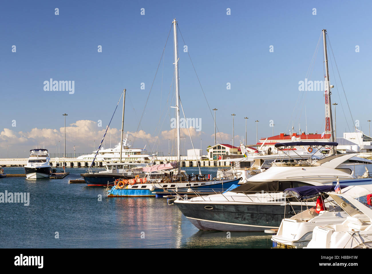 Luxury yachts and private boats moored at pier in Sochi seaport. In ...