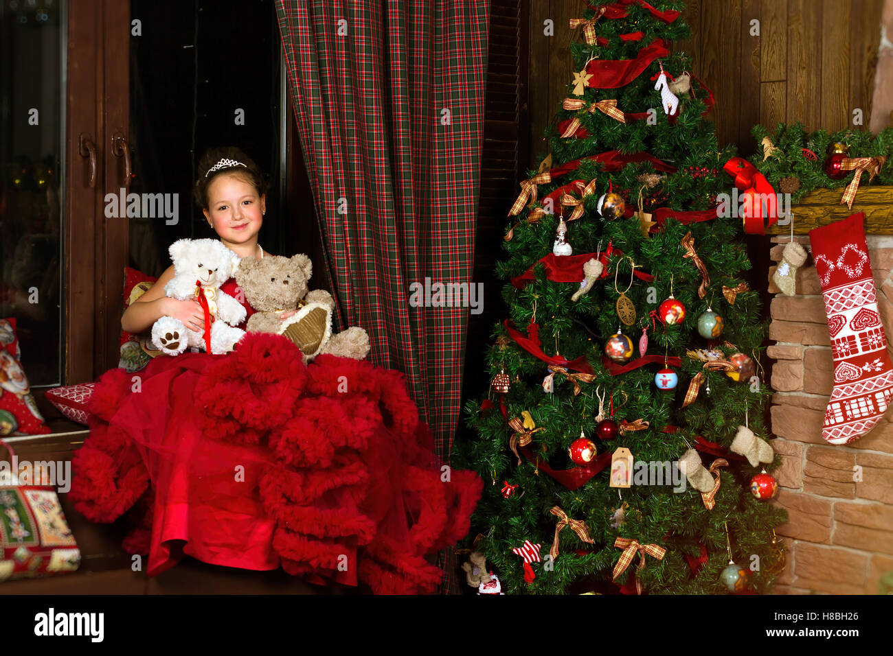 Little winter Princess - girl in red dress, sitting on windowsill and ...
