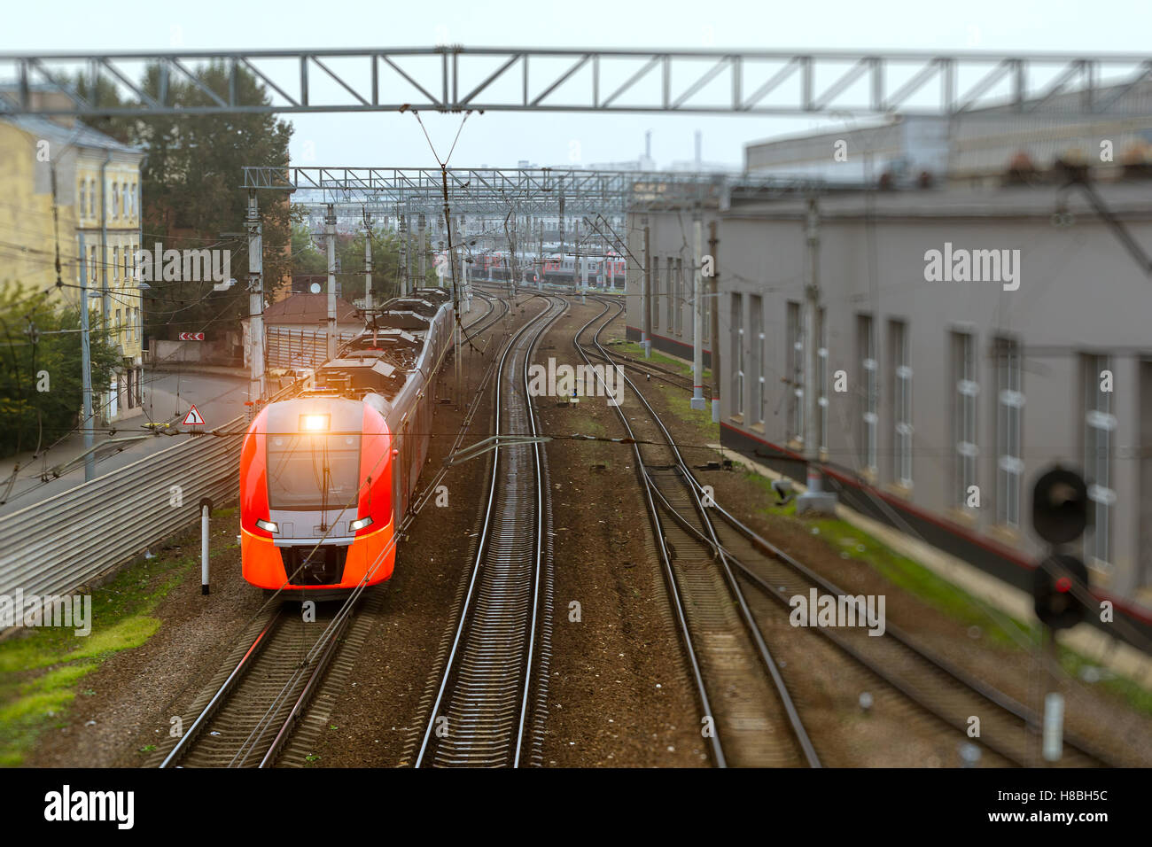 Modern electric locomotive pulling a high-speed train on rails ...
