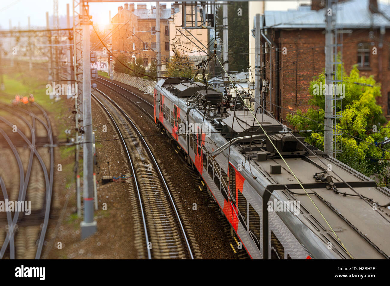 Modern electric locomotive pulling a high-speed train on rails ...