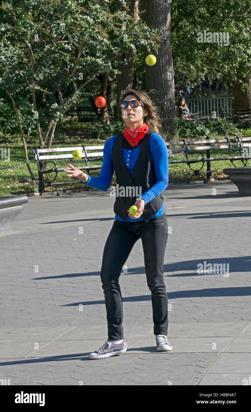 A woman juggler performing for donations in Washington Square Park in ...