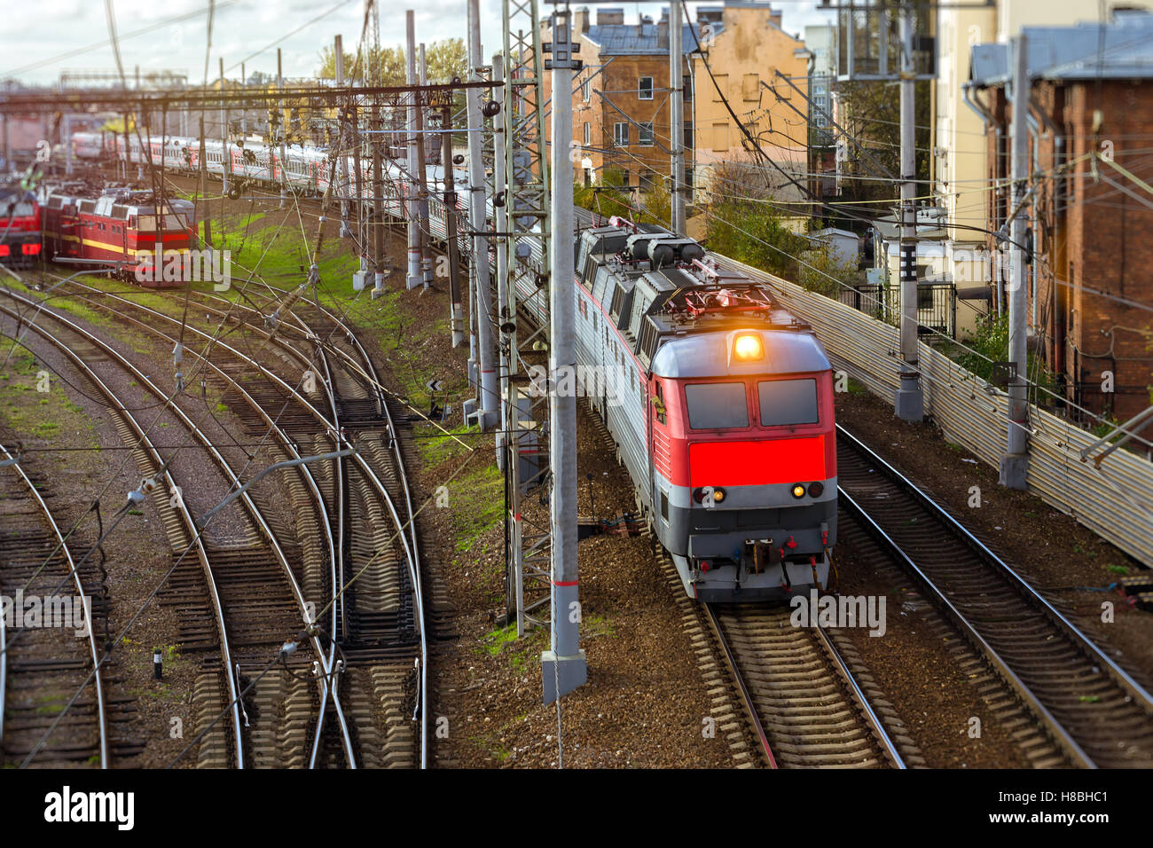 Electric locomotive pulling high-speed train on rails. Technical ...