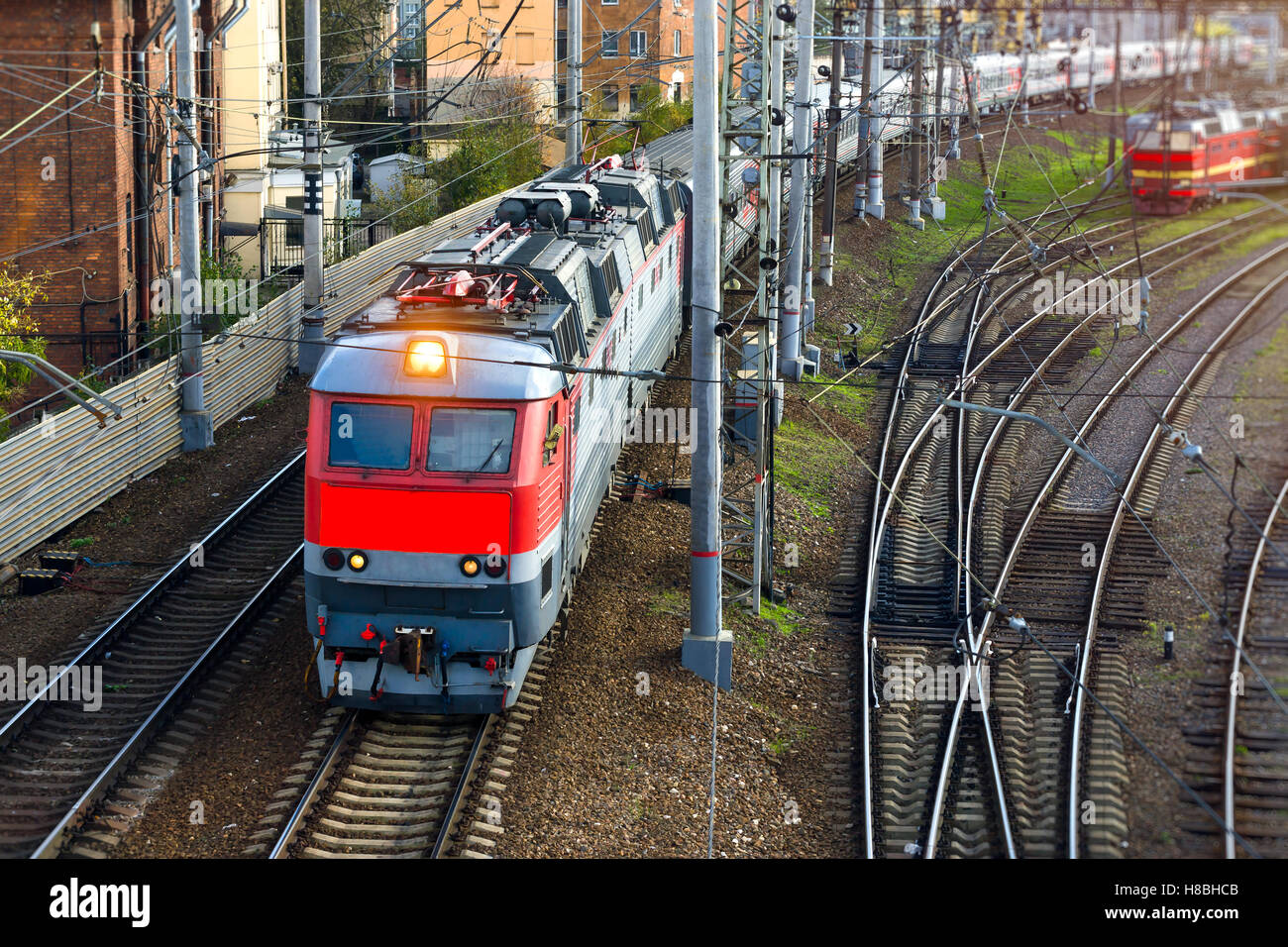 Electric locomotive pulling high-speed train on rails. Technical ...