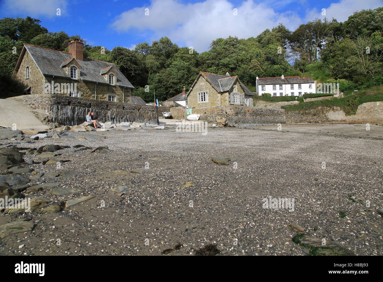 Beach and white cottages at village of durgan hi-res stock photography ...