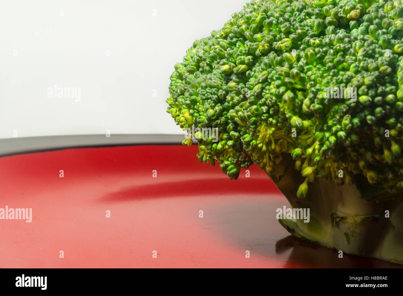 Green Brocolli on Red and Black Plate on White Background Stock Photo ...
