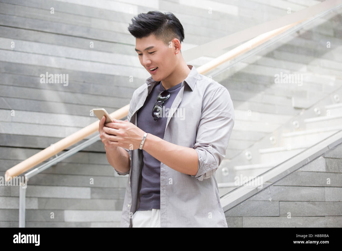 Young Chinese man using a smart phone Stock Photo - Alamy