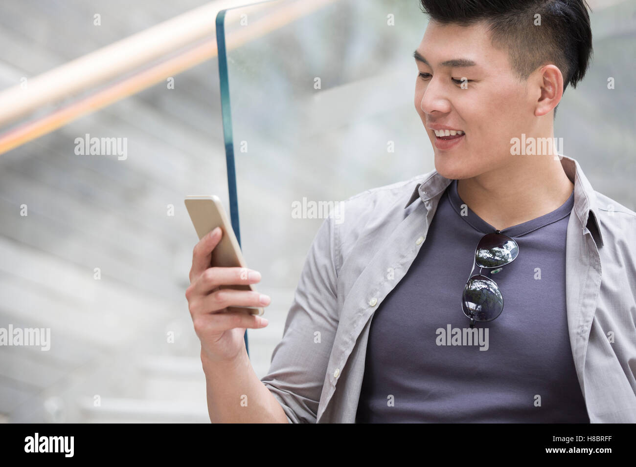 Young Chinese man using a smart phone Stock Photo - Alamy