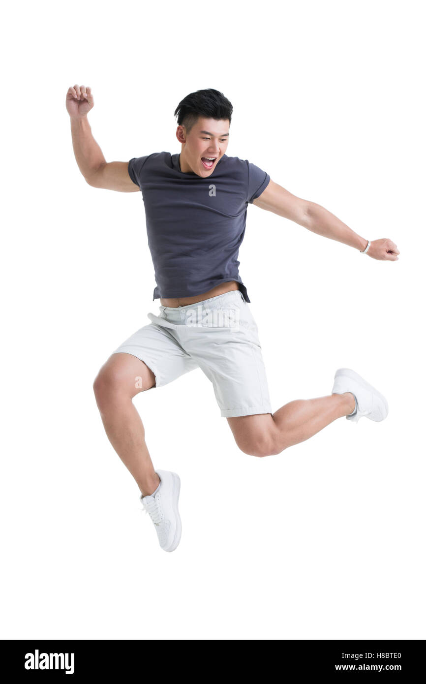 Happy young Chinese man jumping Stock Photo - Alamy