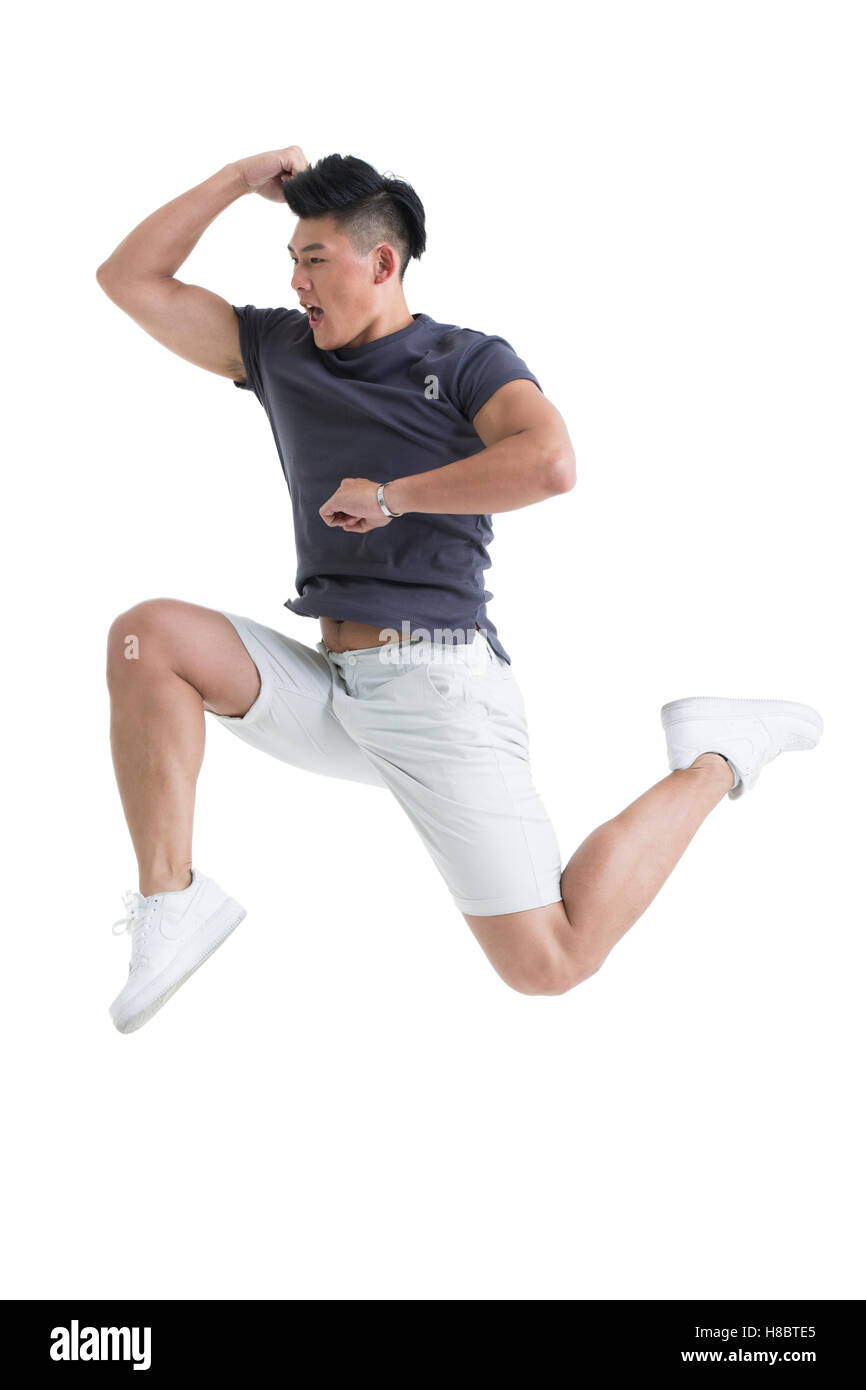 Happy young Chinese man jumping Stock Photo - Alamy
