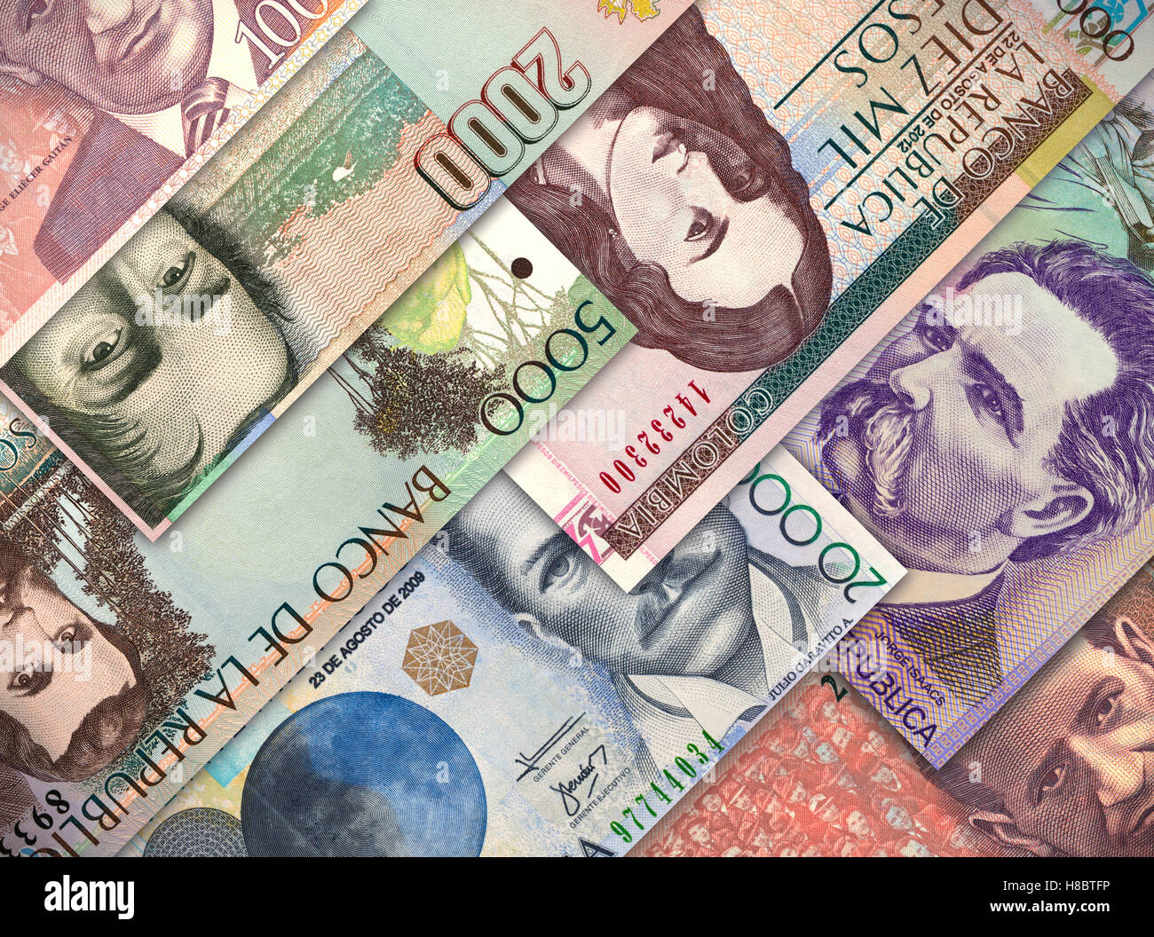 Different money bills stacked over each other forming a money ...