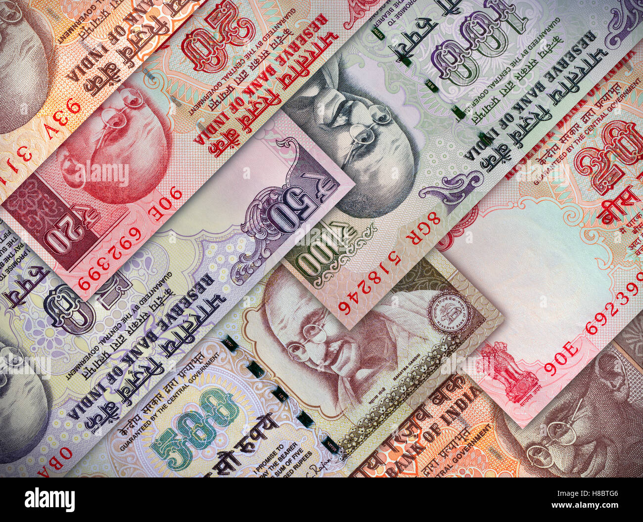 Different money bills stacked over each other forming a money ...