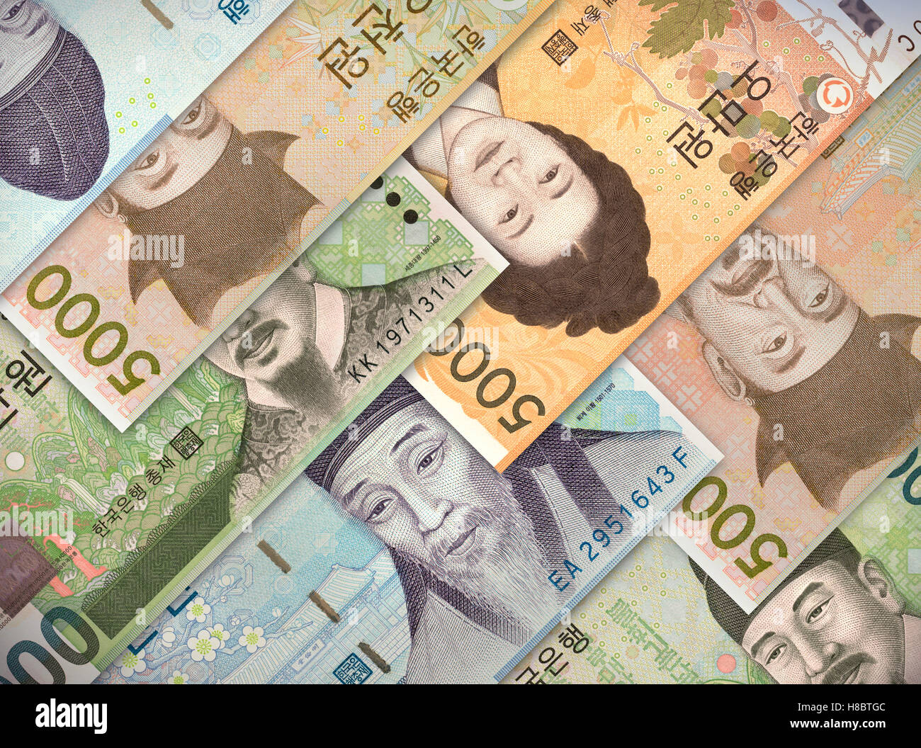 Different money bills stacked over each other forming a money ...