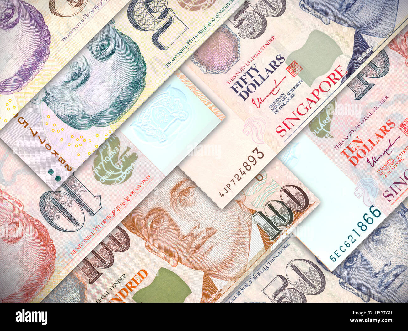 Different money bills stacked over each other forming a money ...