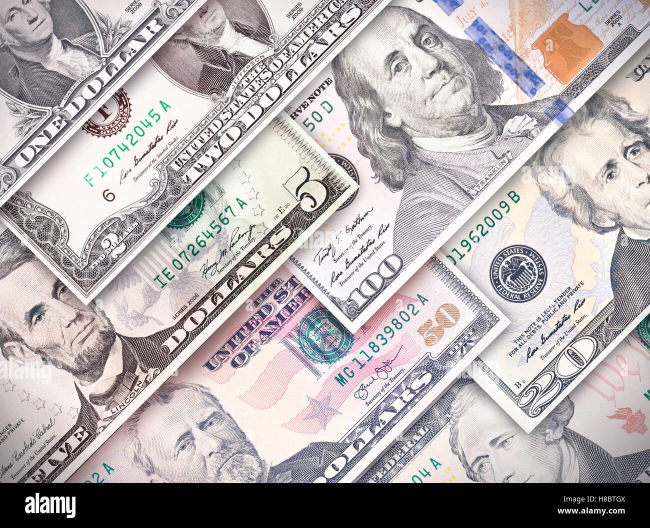 Different money bills stacked over each other forming a money ...