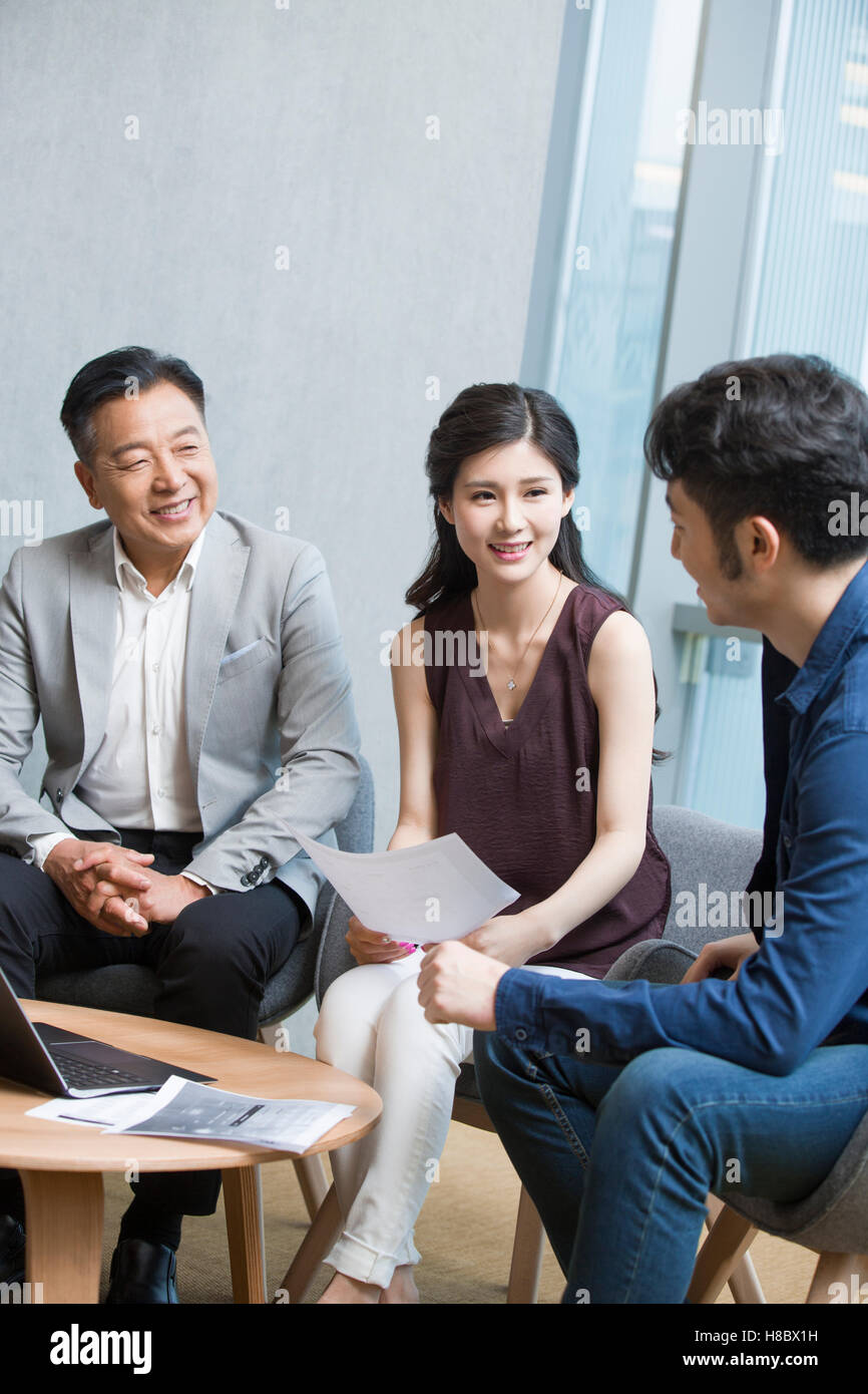 Chinese business people talking in meeting with a laptop Stock Photo ...