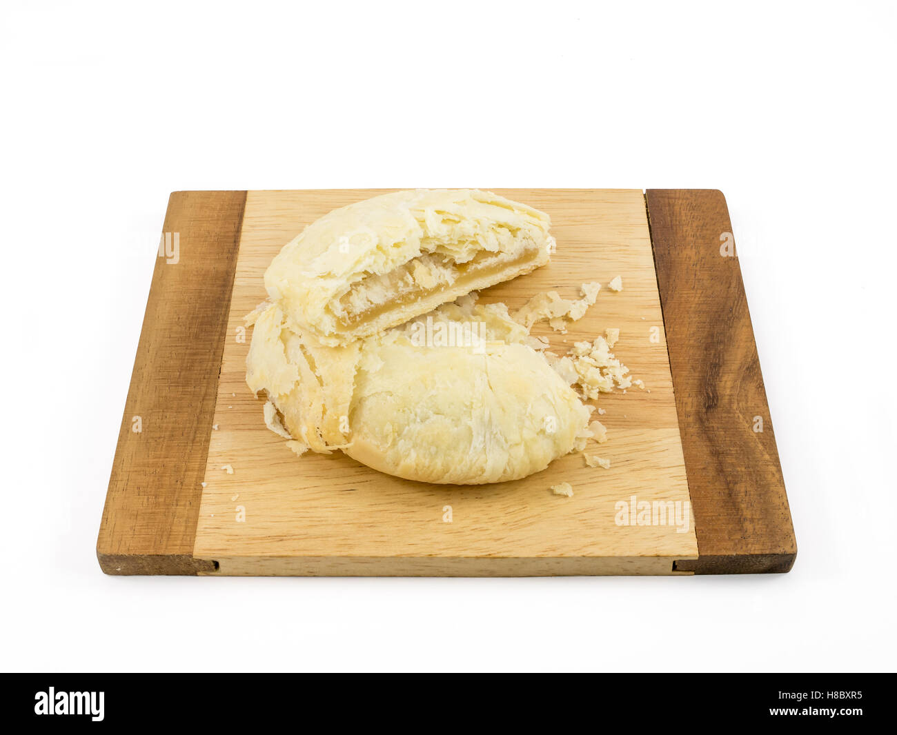 The Taiwanese sun cake (milk butter pastry) on the brown wooden plank ...