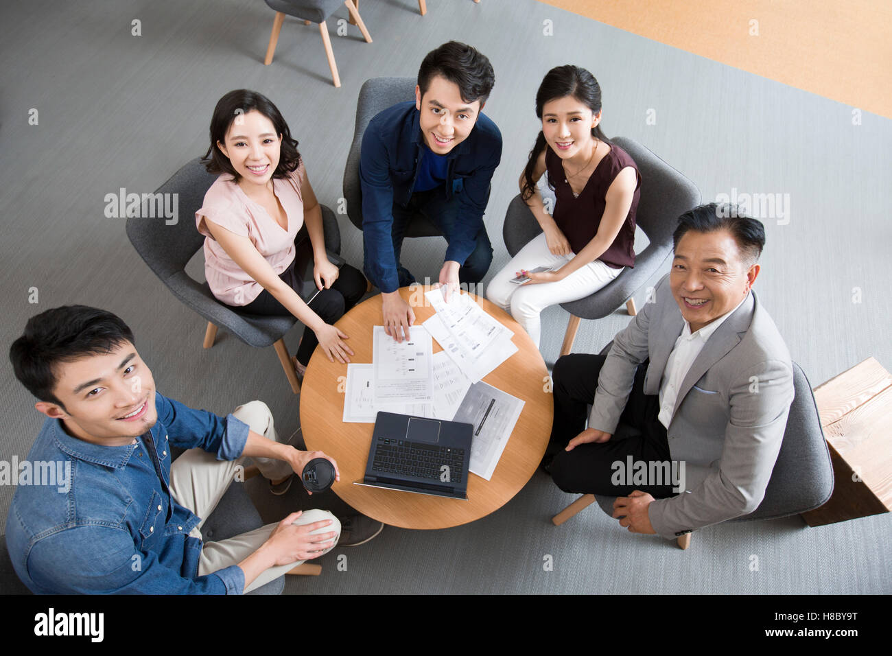 Chinese business people talking in meeting with a laptop Stock Photo ...
