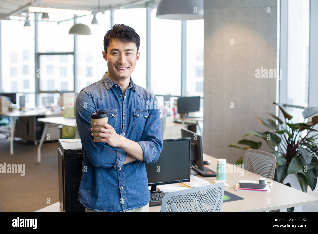 Portrait of confident young Chinese man in office Stock Photo - Alamy