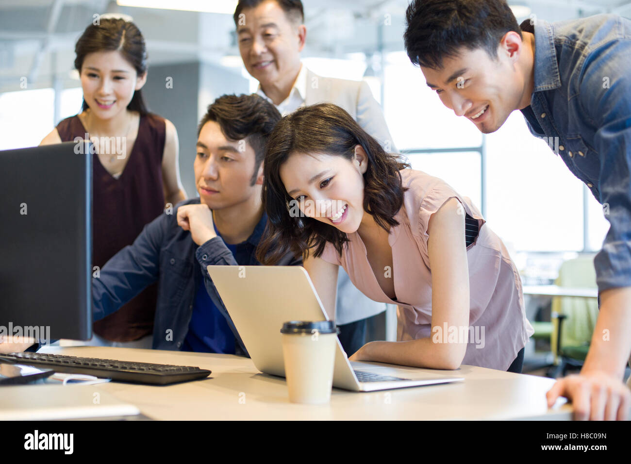 Chinese business people working together with computer and laptop Stock Photo - Alamy