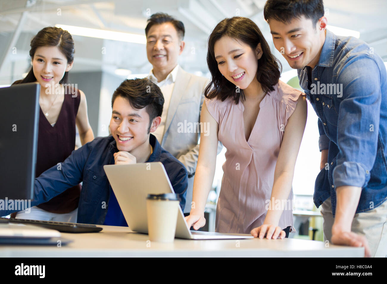 Chinese business people working together with computer and laptop Stock ...