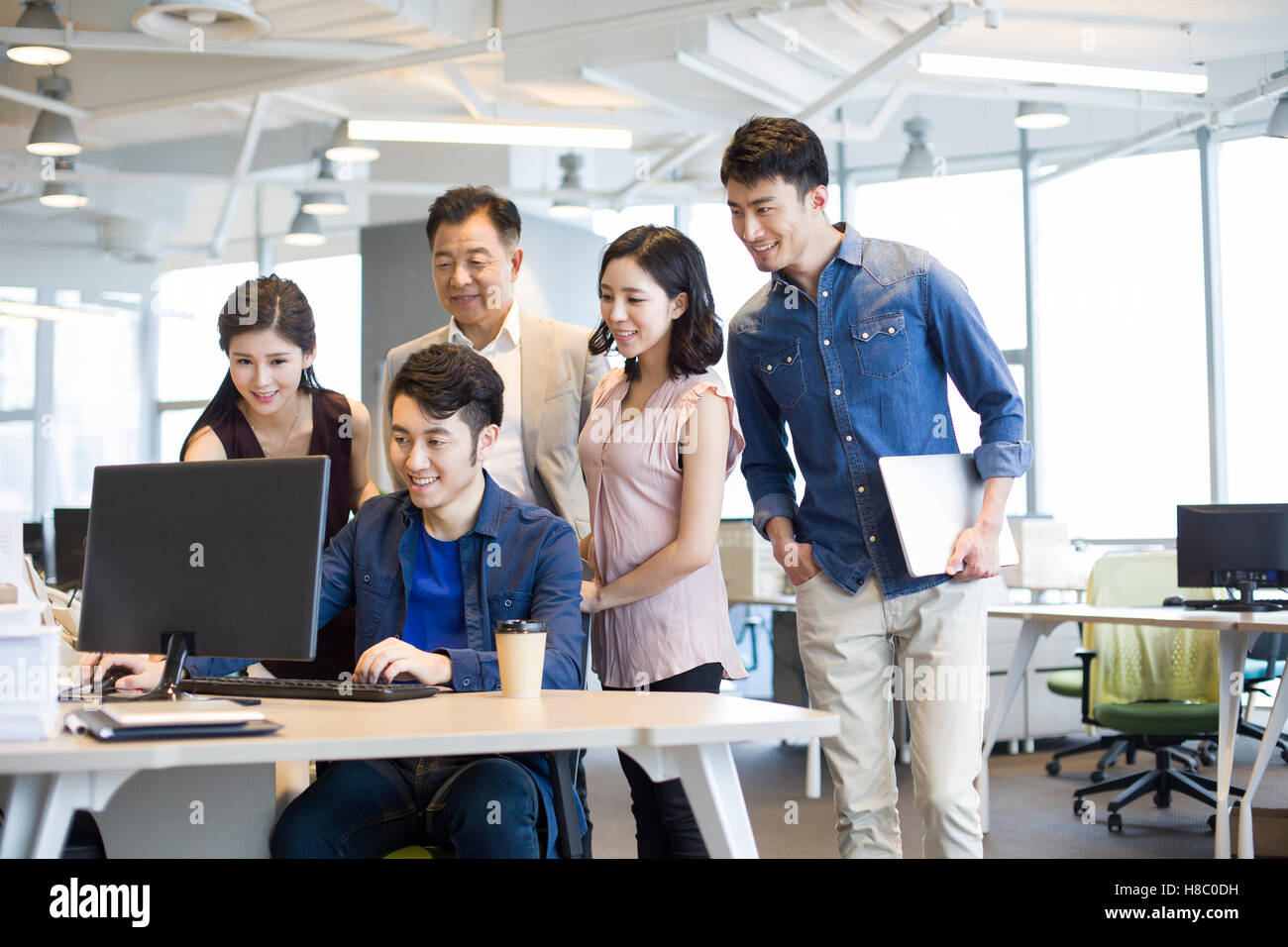 Chinese business people working together with computer Stock Photo - Alamy
