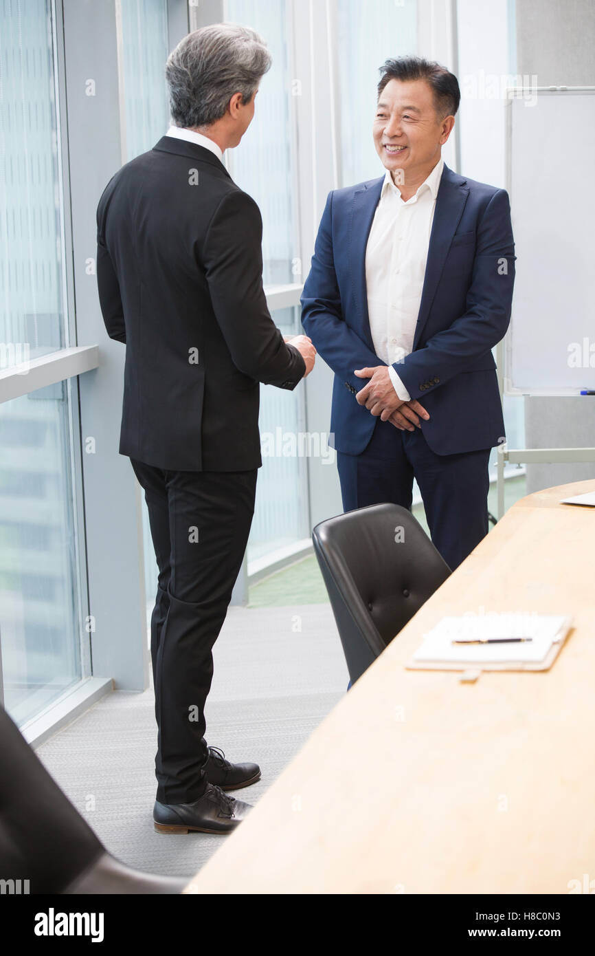 Chinese businessmen talking in meeting room Stock Photo - Alamy
