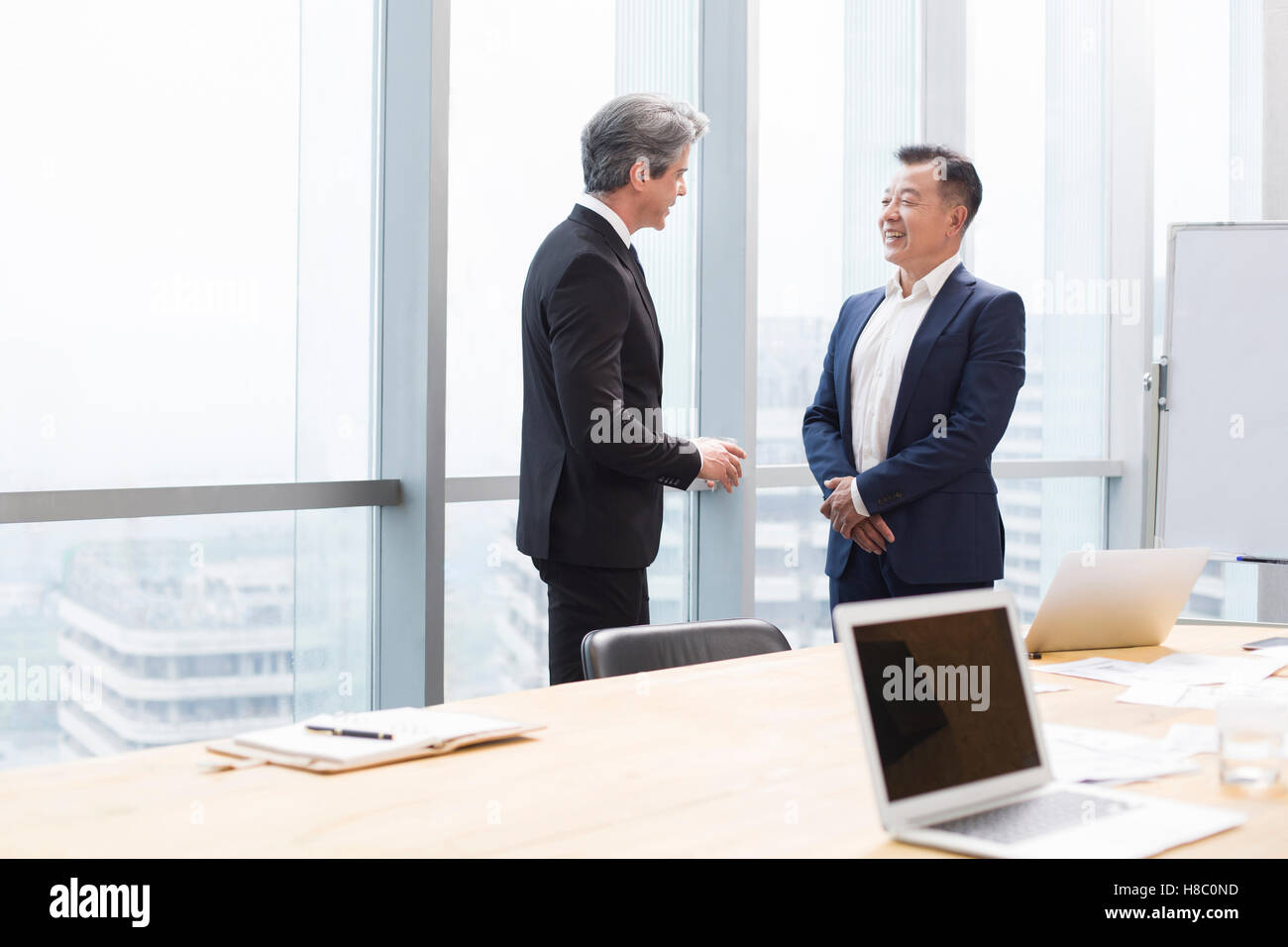 Chinese businessmen talking in meeting room Stock Photo - Alamy