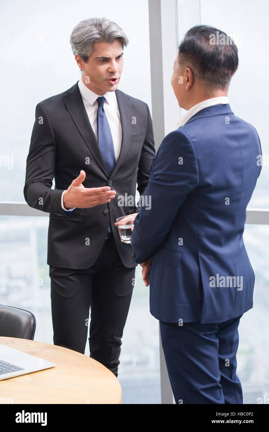 Chinese businessmen talking in meeting room Stock Photo - Alamy