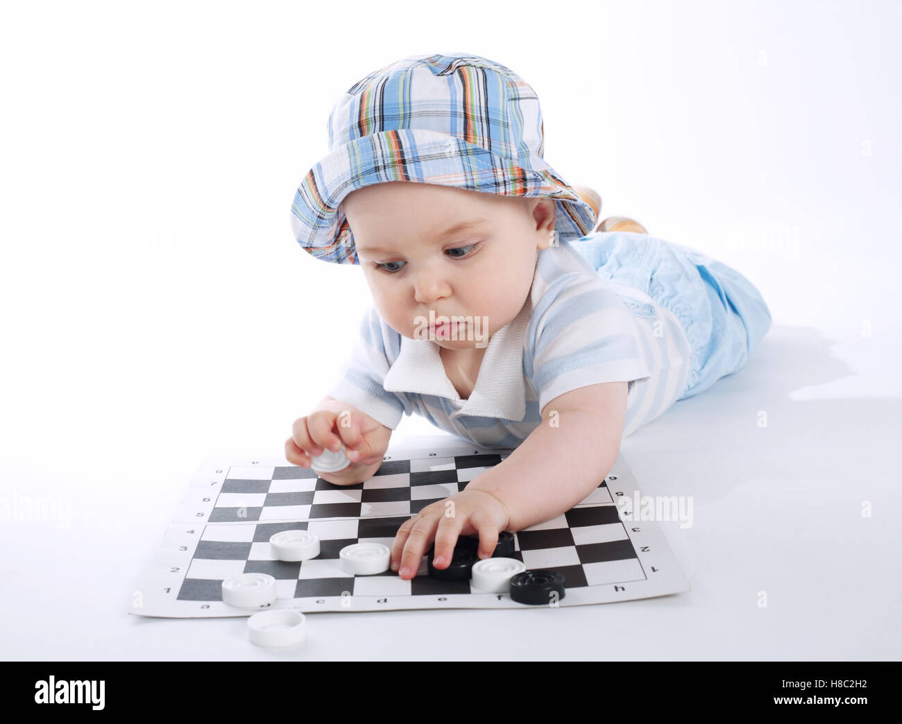 baby playing checkers on white Stock Photo - Alamy