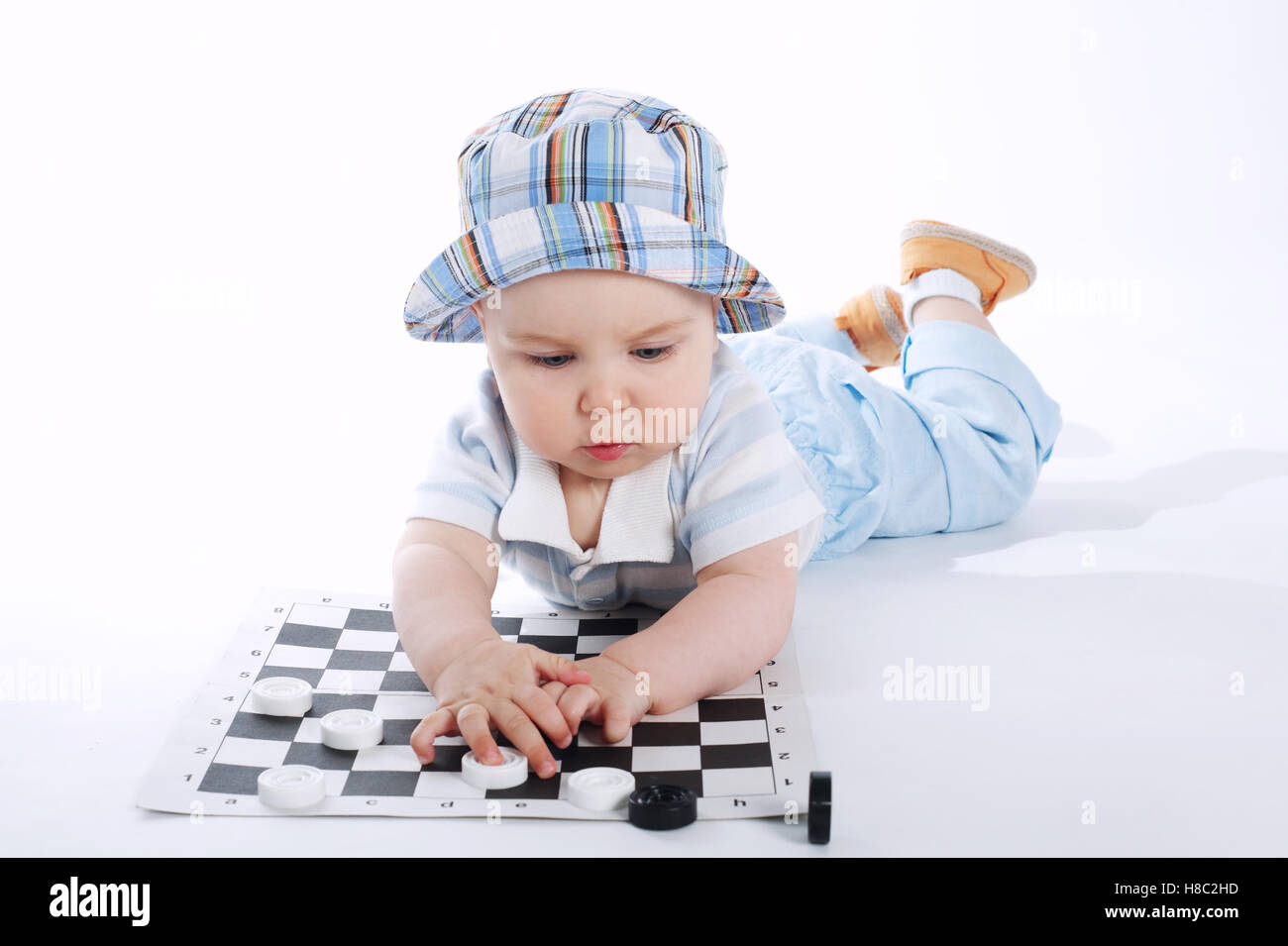 baby playing checkers on white Stock Photo - Alamy