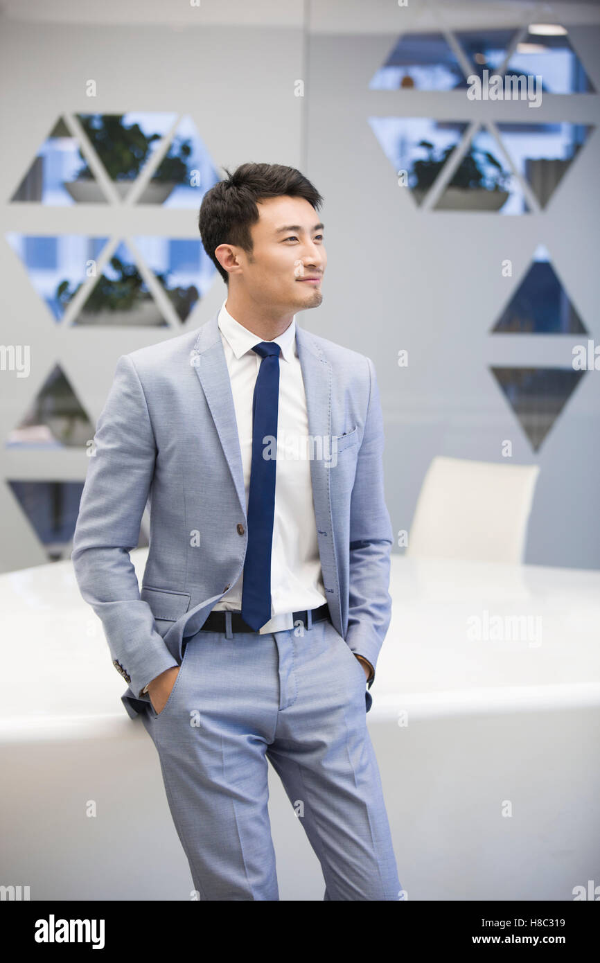 Young Chinese businessman thinking Stock Photo - Alamy