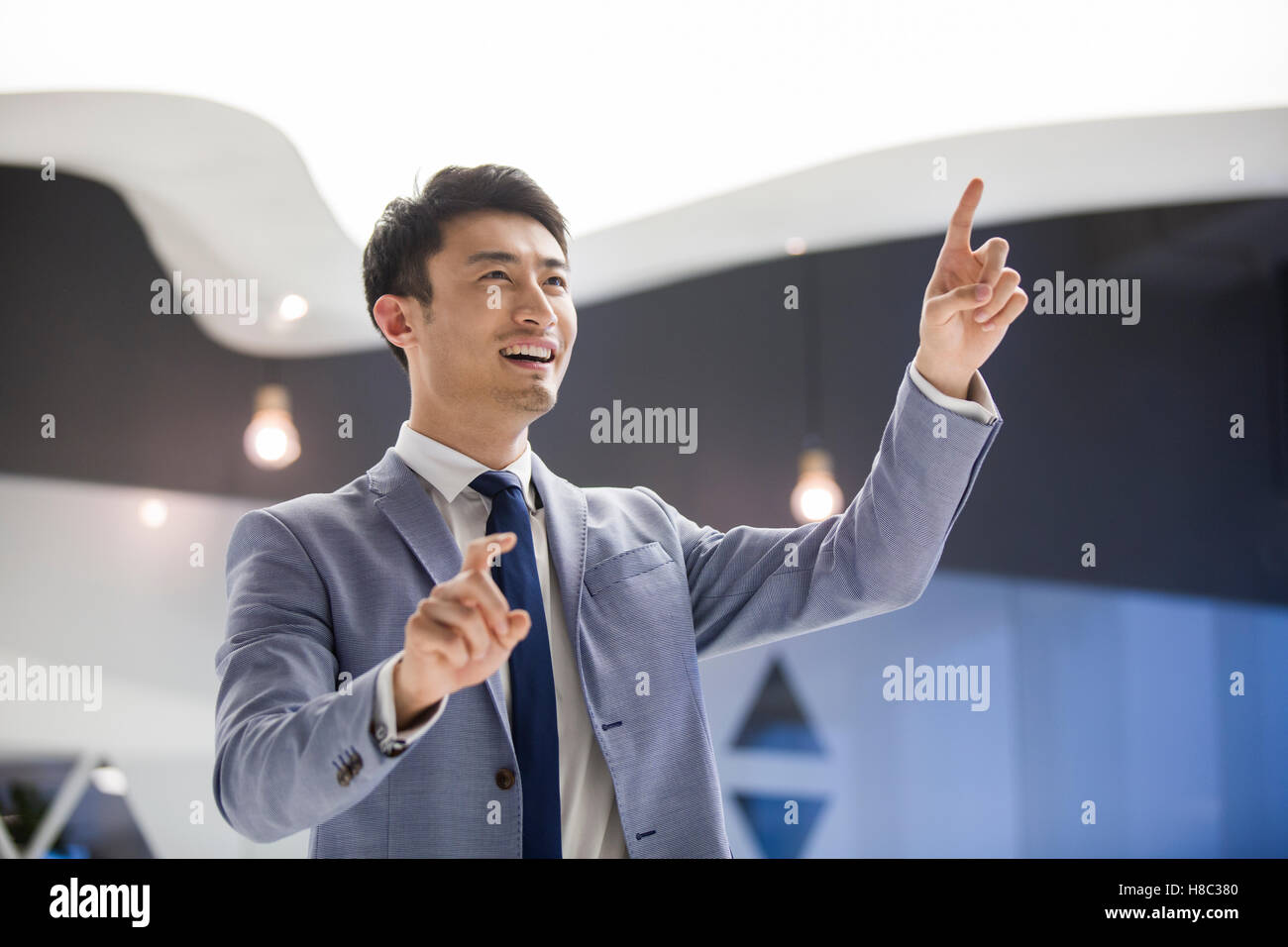 Young Chinese businessman using finger to point Stock Photo - Alamy